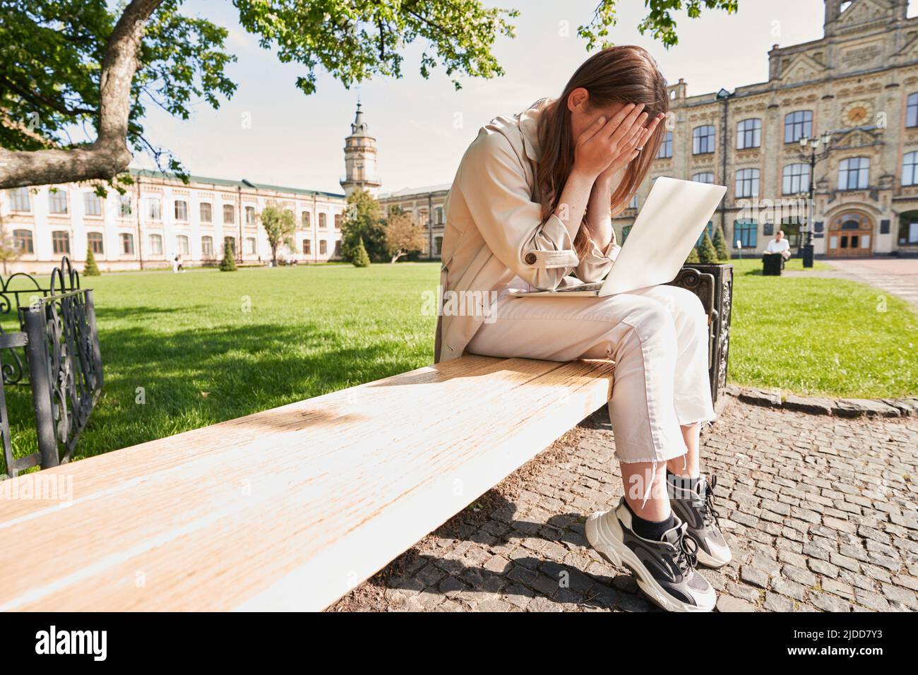 Lady covered her face with hands on bench in park Stock Photo - Alamy