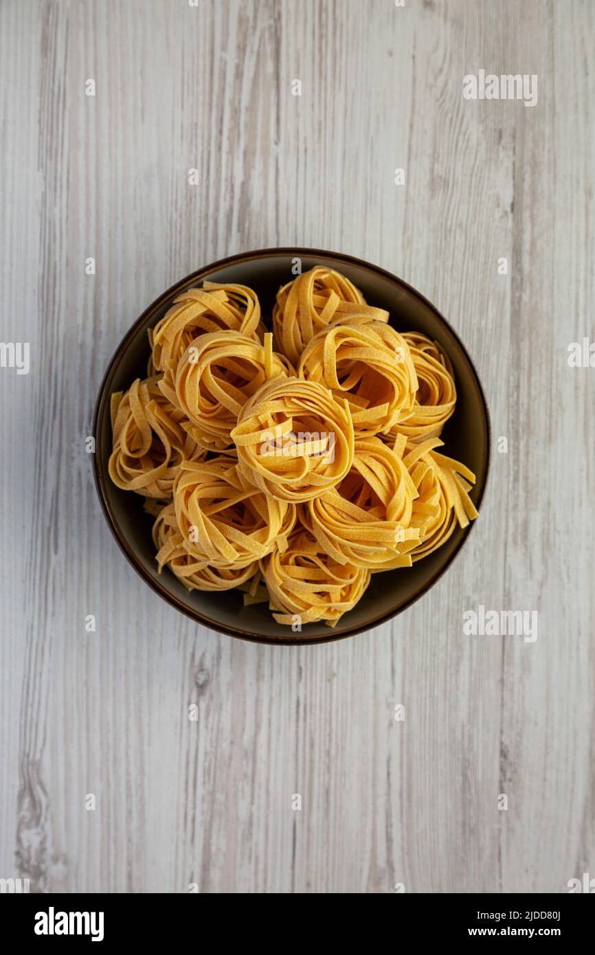 Homemade Organic Dry Tagliatelle Pasta in a Bowl, top view. Flat lay ...