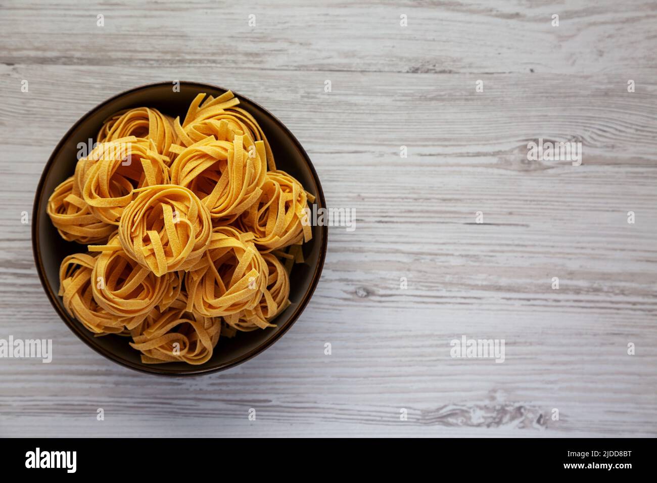 Homemade Organic Dry Tagliatelle Pasta in a Bowl, top view. Flat lay ...