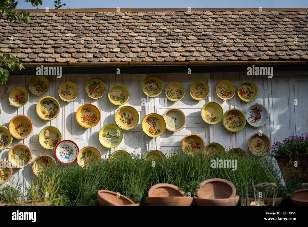 Enamelware used basin with patterns on wooden wall of house used as ...