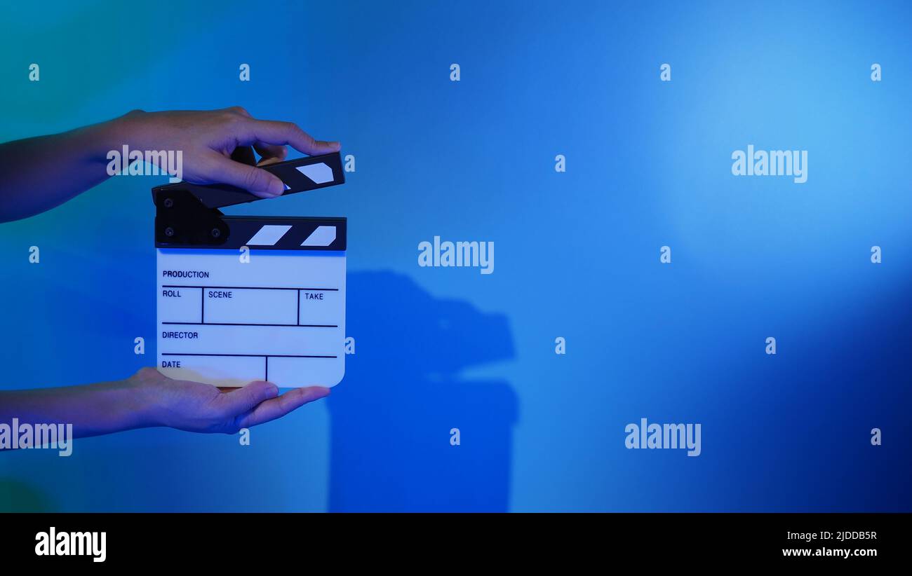 Movie Clapper board. Crew hand holding plastic and wooden film slate ...