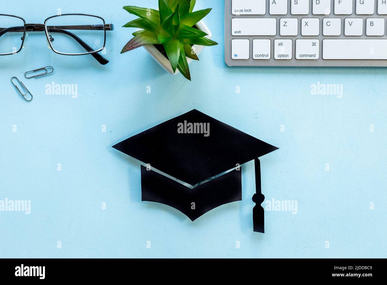Academic cap or graduation hat on students desk. Education concept ...