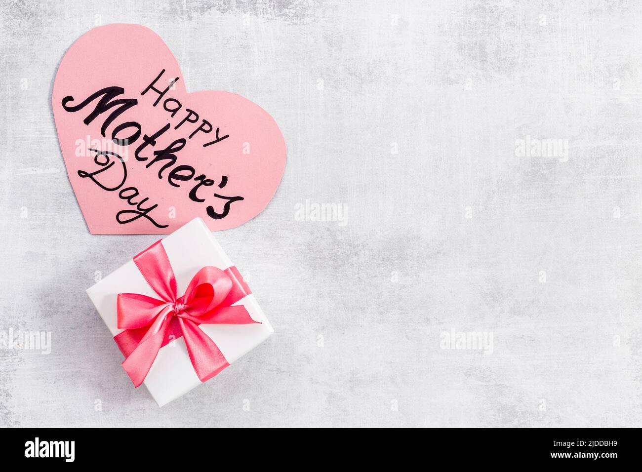 Gift box with pink ribbon over Happy Mothers day greeting card Stock ...