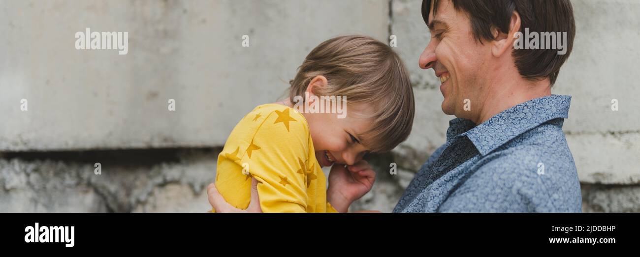 man dad having quality time with their kid son boy six year old on arms ...
