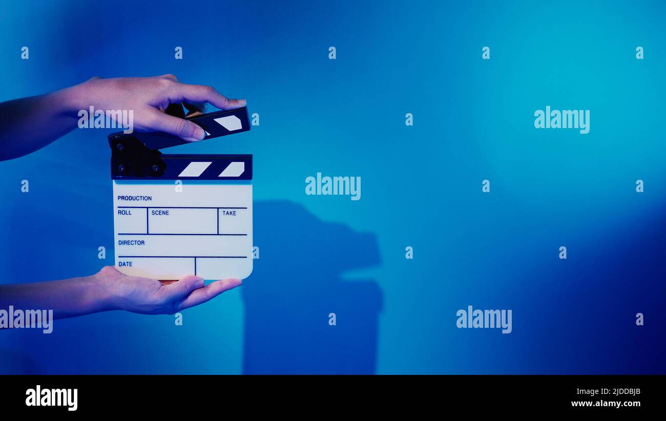 Movie Clapper board. Crew hand holding plastic and wooden film slate ...