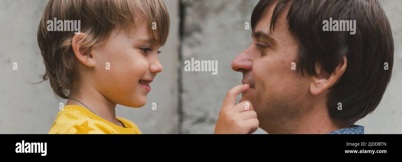 man dad having quality time with their kid son boy six year old on arms ...