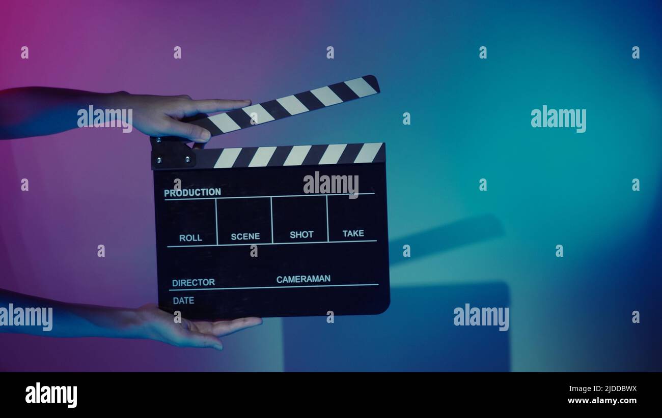 Movie Clapper board. Crew hand holding plastic and wooden film slate ...