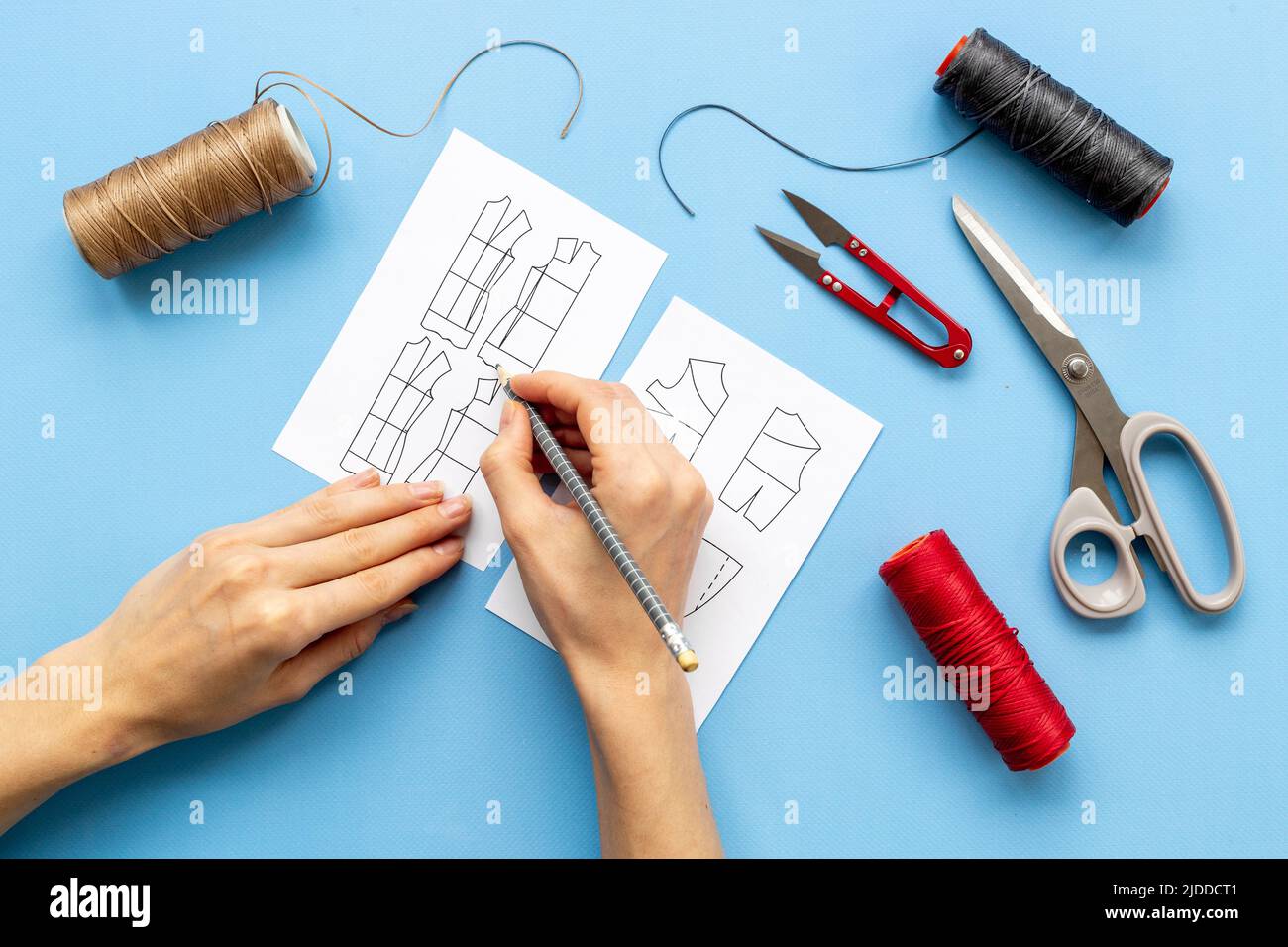 Female hands holding sewing patterns. Sewing background for dress ...