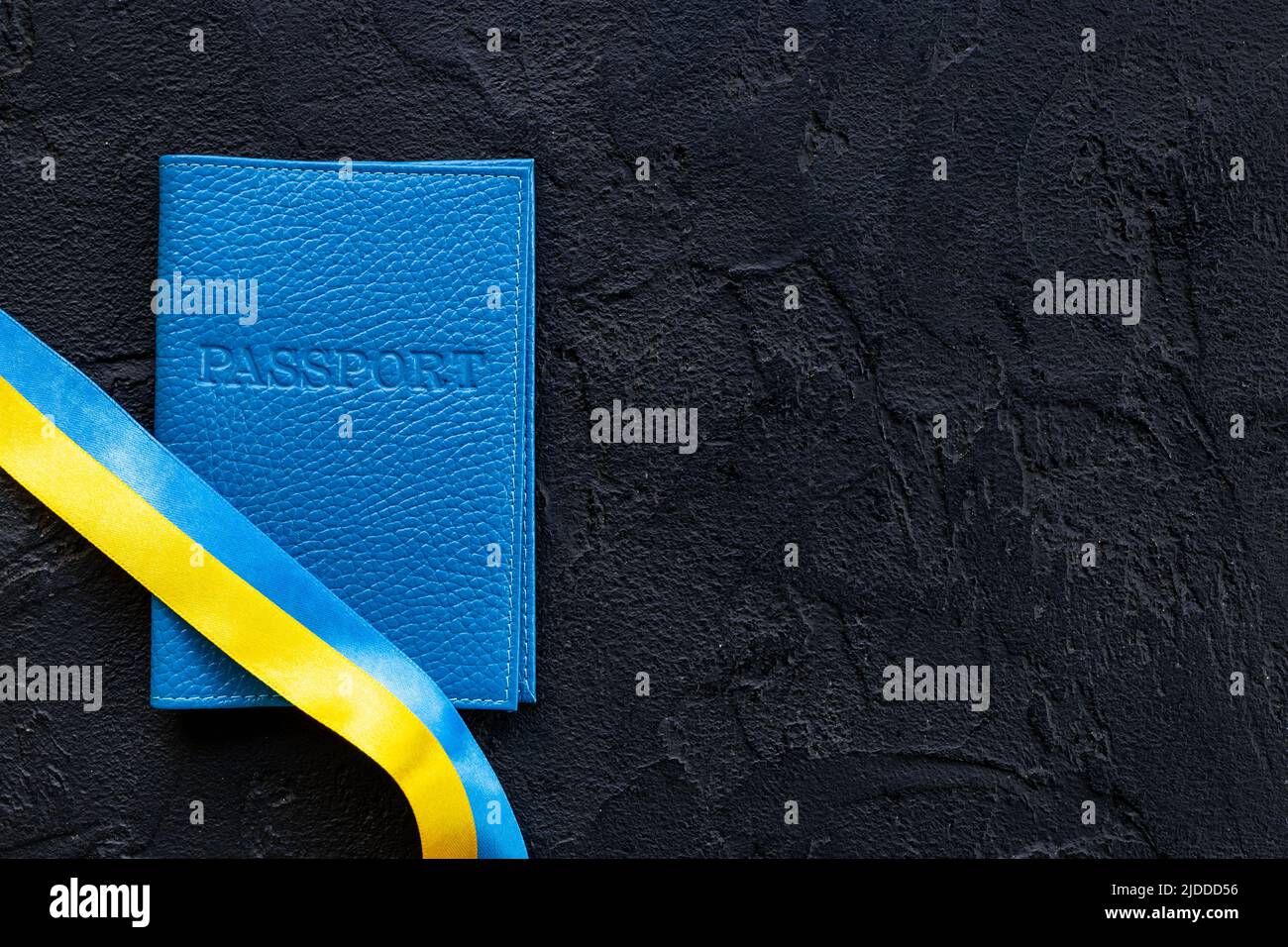 Ukrainian immigration concept - yellow and blue ribbon on passport ...