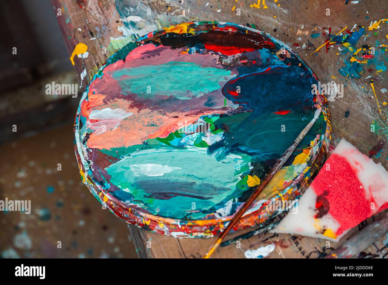 Bright spots of paint and a brush in an art workshop Stock Photo - Alamy