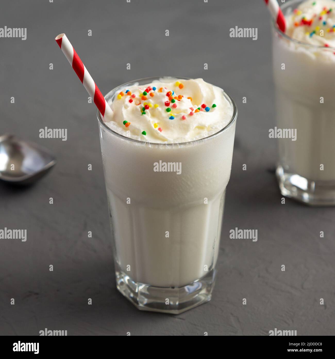 Homemade Vanilla Milk Shake with Whipped Cream, side view. Close-up ... Homemade Vanilla Milk Shake with Whipped Cream, side view. Close-up ...