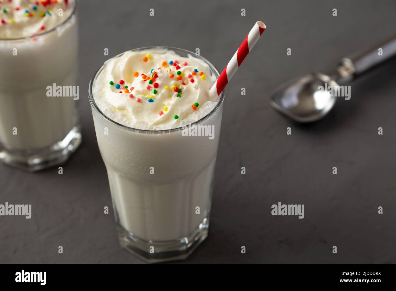 Homemade Vanilla Milk Shake with Whipped Cream, side view. Close-up ...