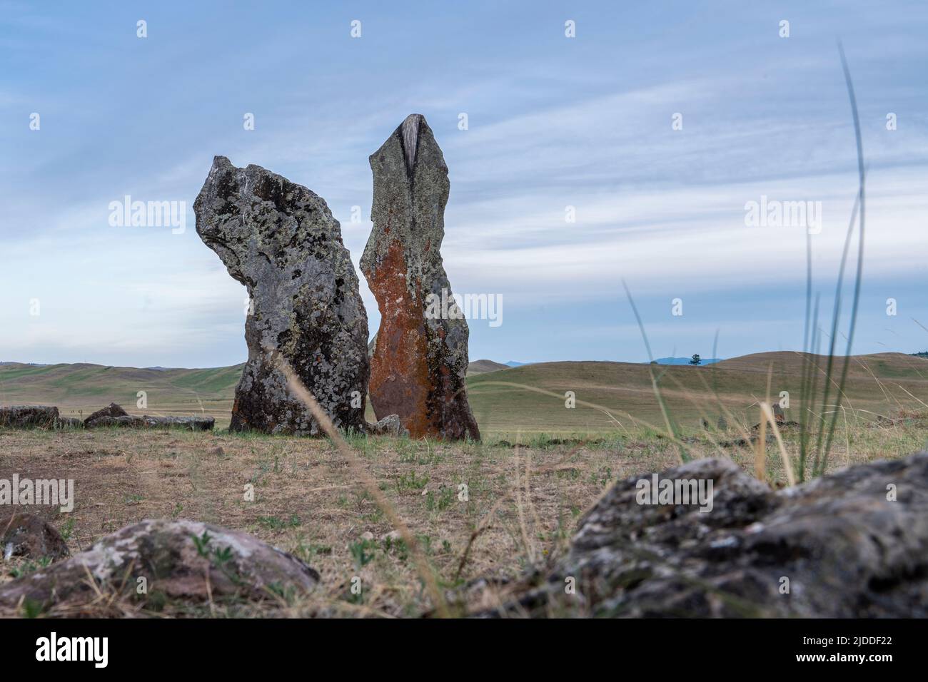 stone idols in the steppe on the background of sunset. place of power ...