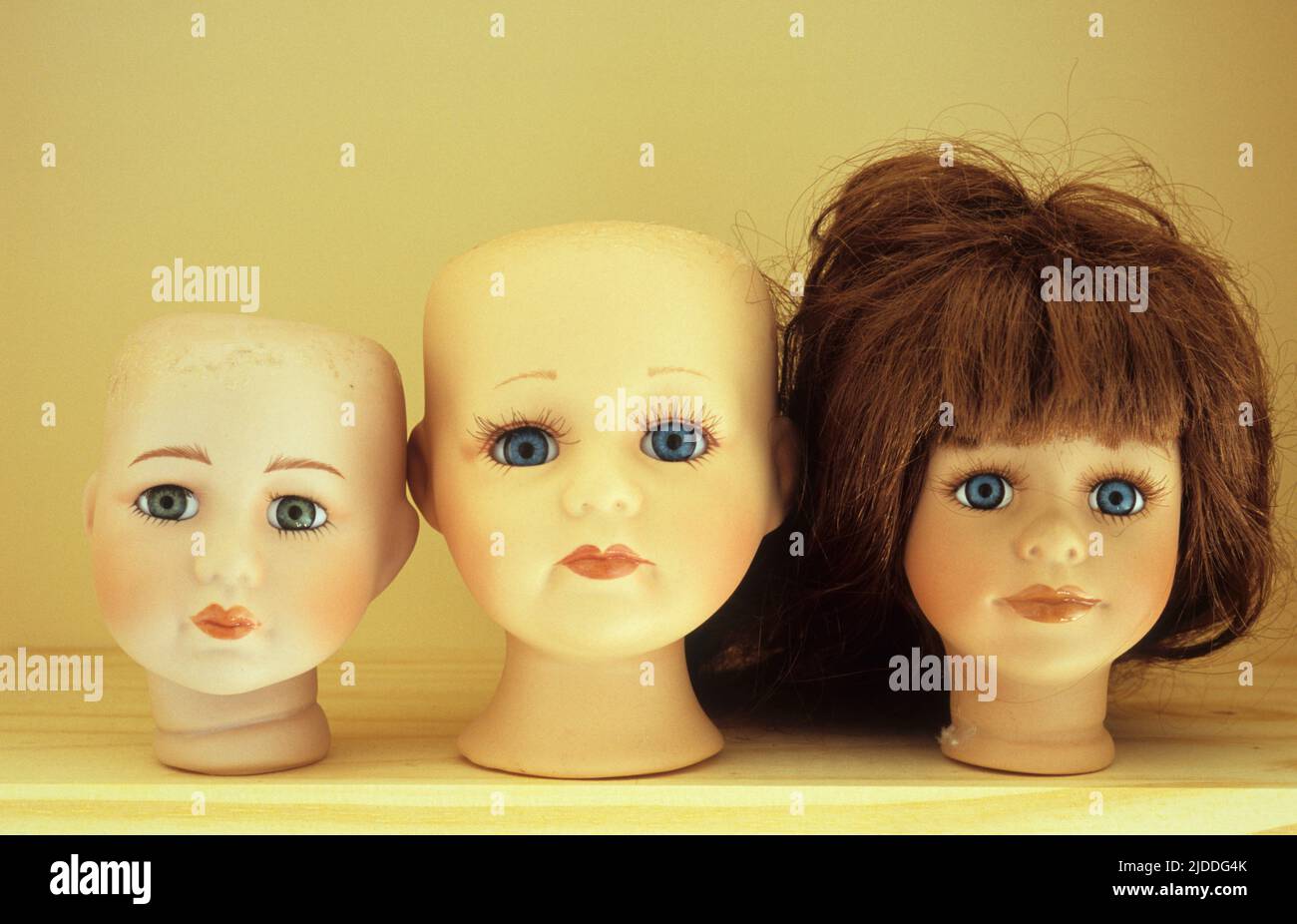 Three doll heads Stock Photo - Alamy