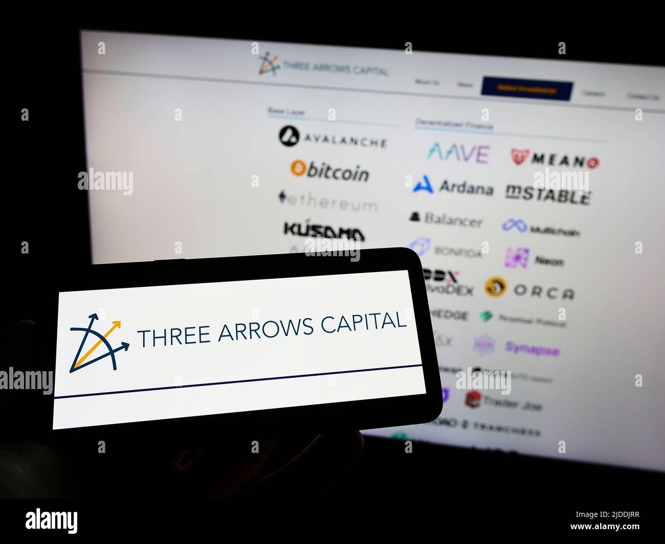 Person holding cellphone with logo of American investment company Three ...