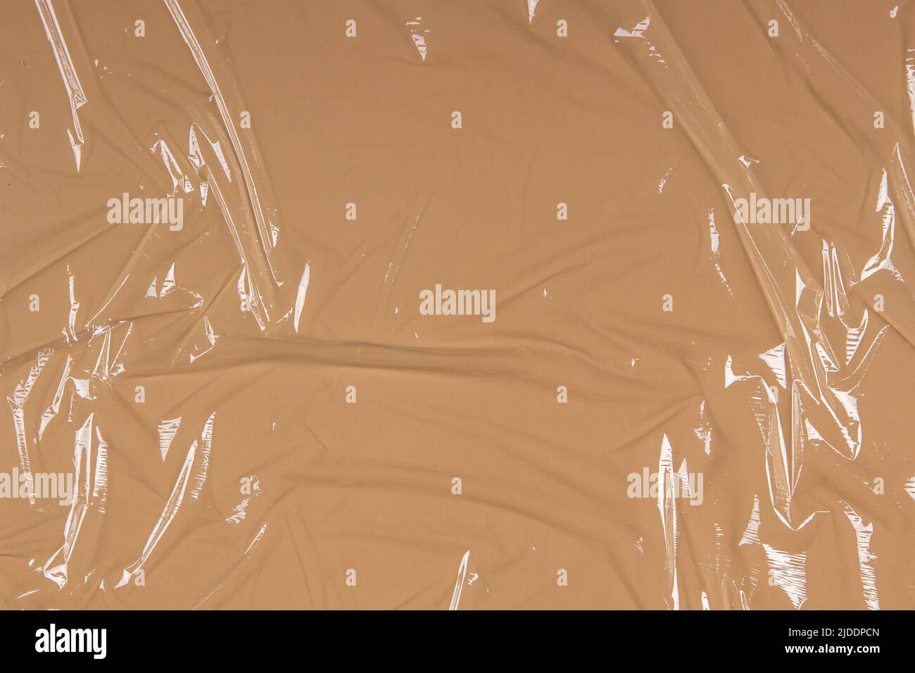 Crumpled wrinkled plastic transparent plastic cellophane on pastel ...