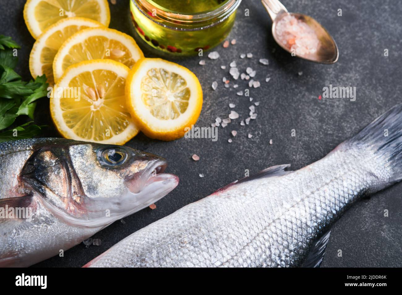 Sea Bass raw. Fresh sea fish bass with salt, pepper, parsley, olive oil ...