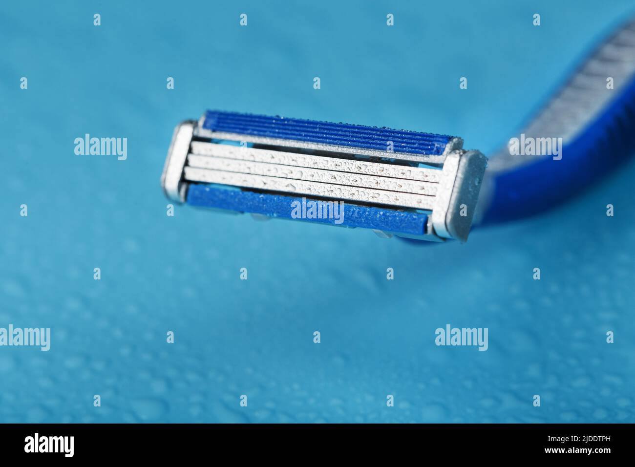 Shaving machine with three blades on a blue background close-up free ...