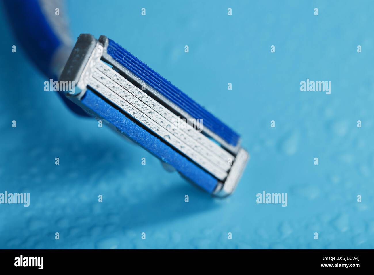 Shaving machine with three blades on a blue background close-up free ...