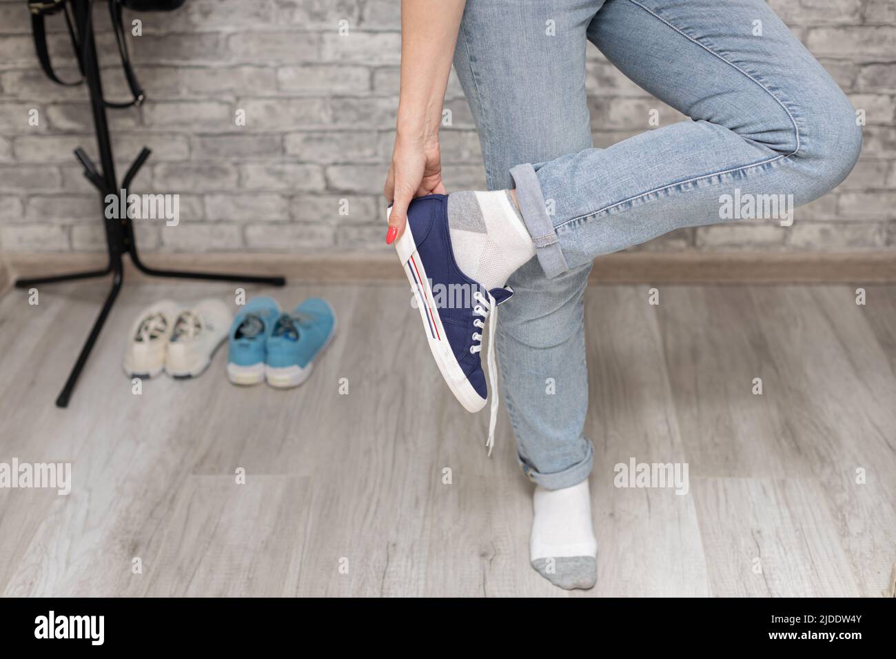 Woman taking off shoes hi-res stock photography and images - Alamy