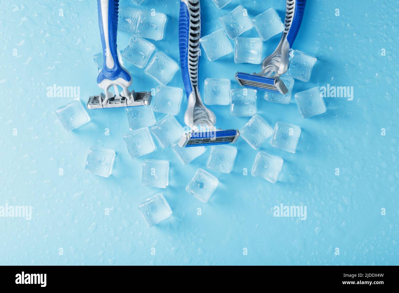 Shaving machine on a blue background with ice cubes. The concept of ...