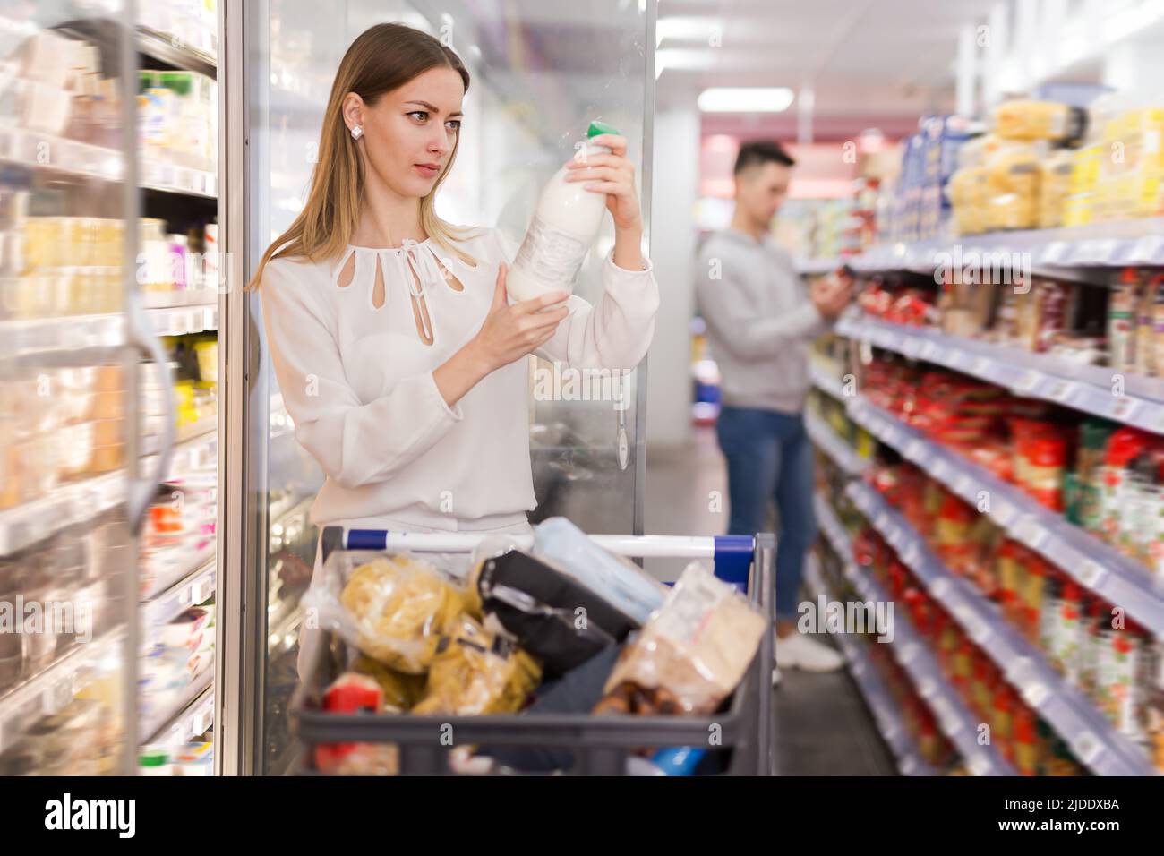 Female consumer buying milk hi-res stock photography and images - Alamy
