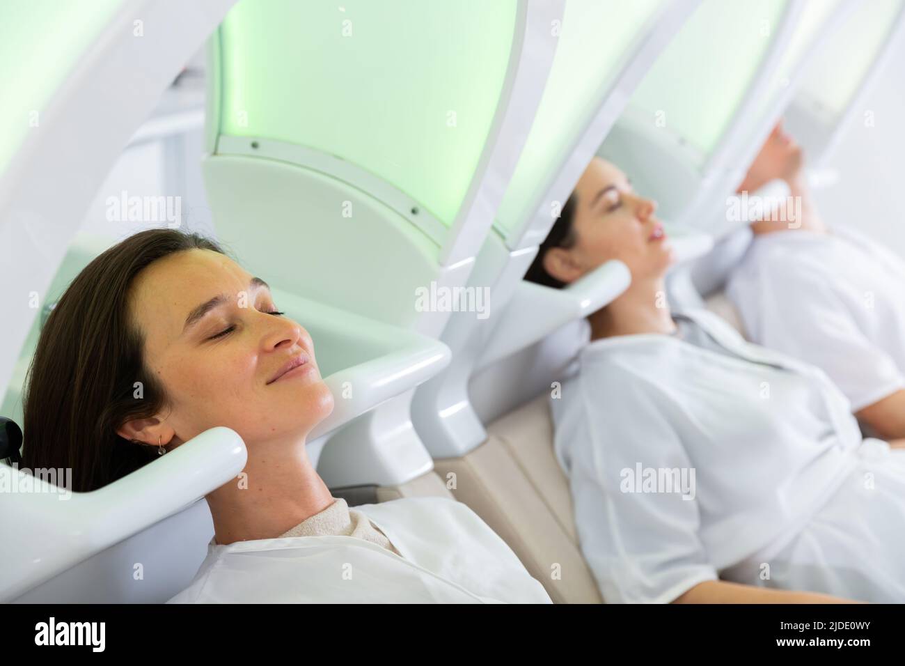 Clients of beauty salon relaxing on massaging chairs Stock Photo - Alamy