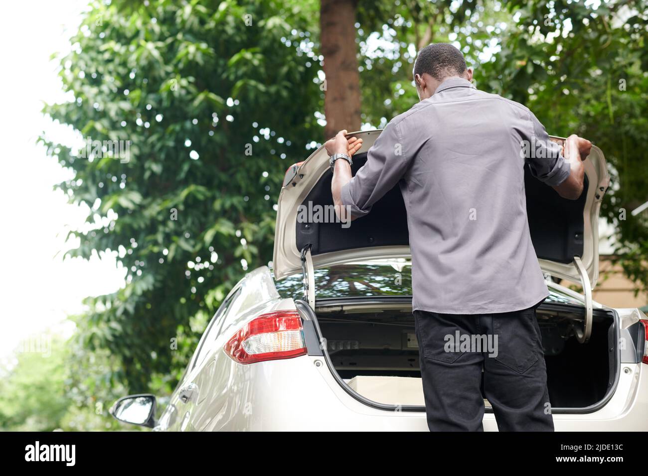 Car owner opening trunk to clean inside and organize space Stock Photo ...