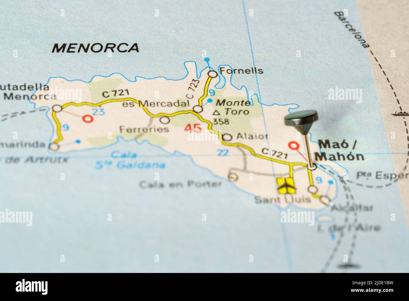 Tourist destination of Menorca marked with a pin on a map, macro photo ...