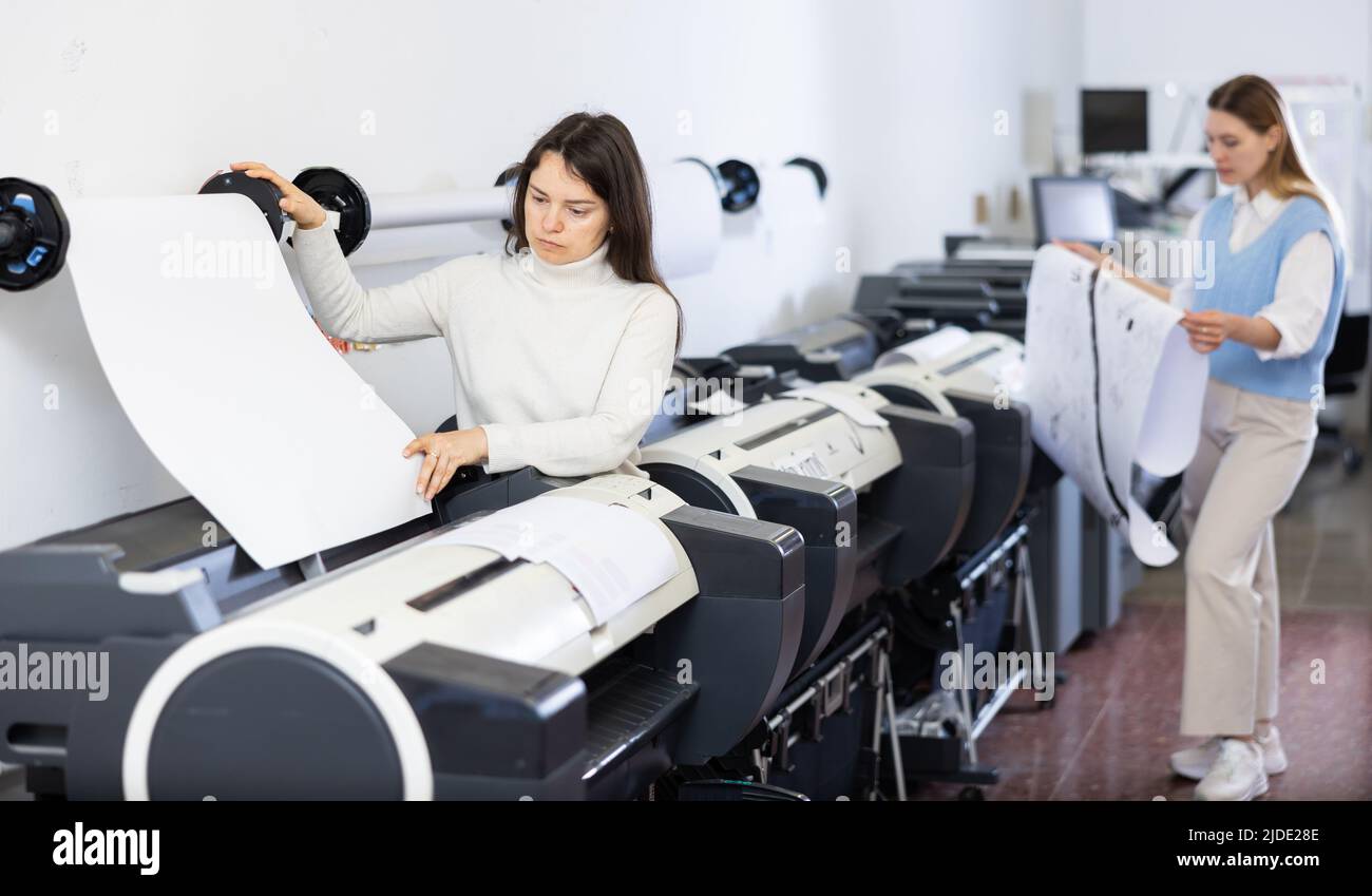 Woman working in printing office, using printer Stock Photo - Alamy