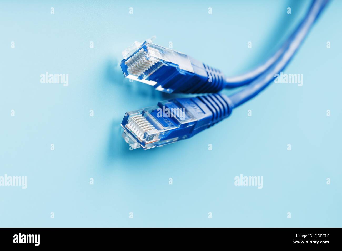 Blue Ethernet Cable Connectors Patch cord cord close-up isolated on a ...