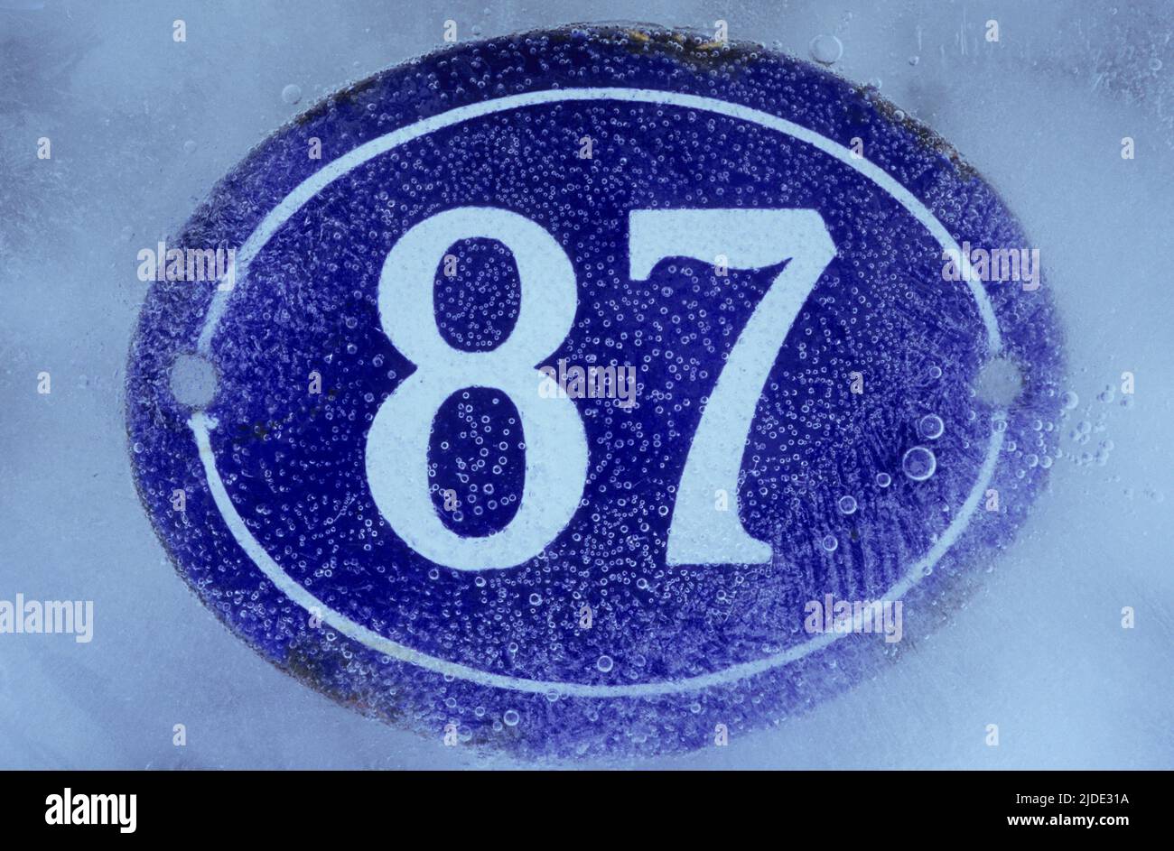 Blue and white enamel continental-style house number plate with figures ...