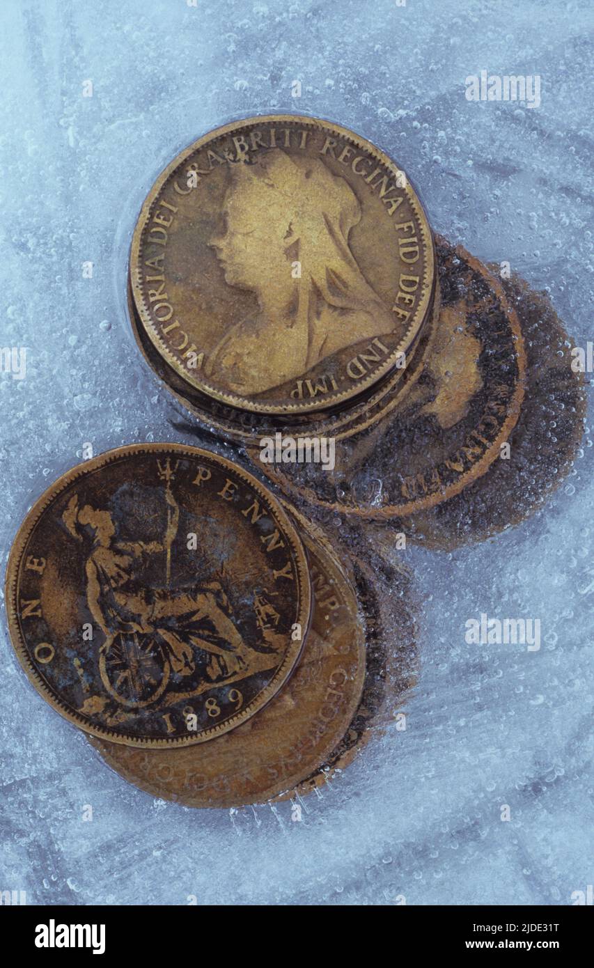 Nine Victorian English penny coins in two piles in block of ice Stock ...