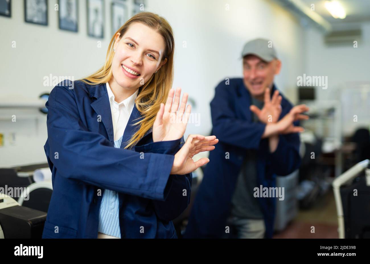 Engineer and office worker having fun dancing in print shop Stock Photo ...