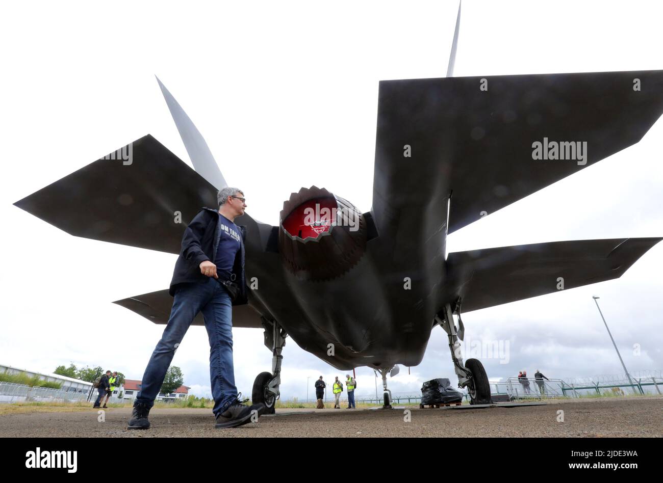 20 June 2022, Brandenburg, Schönefeld: A man walks past a model of an ...