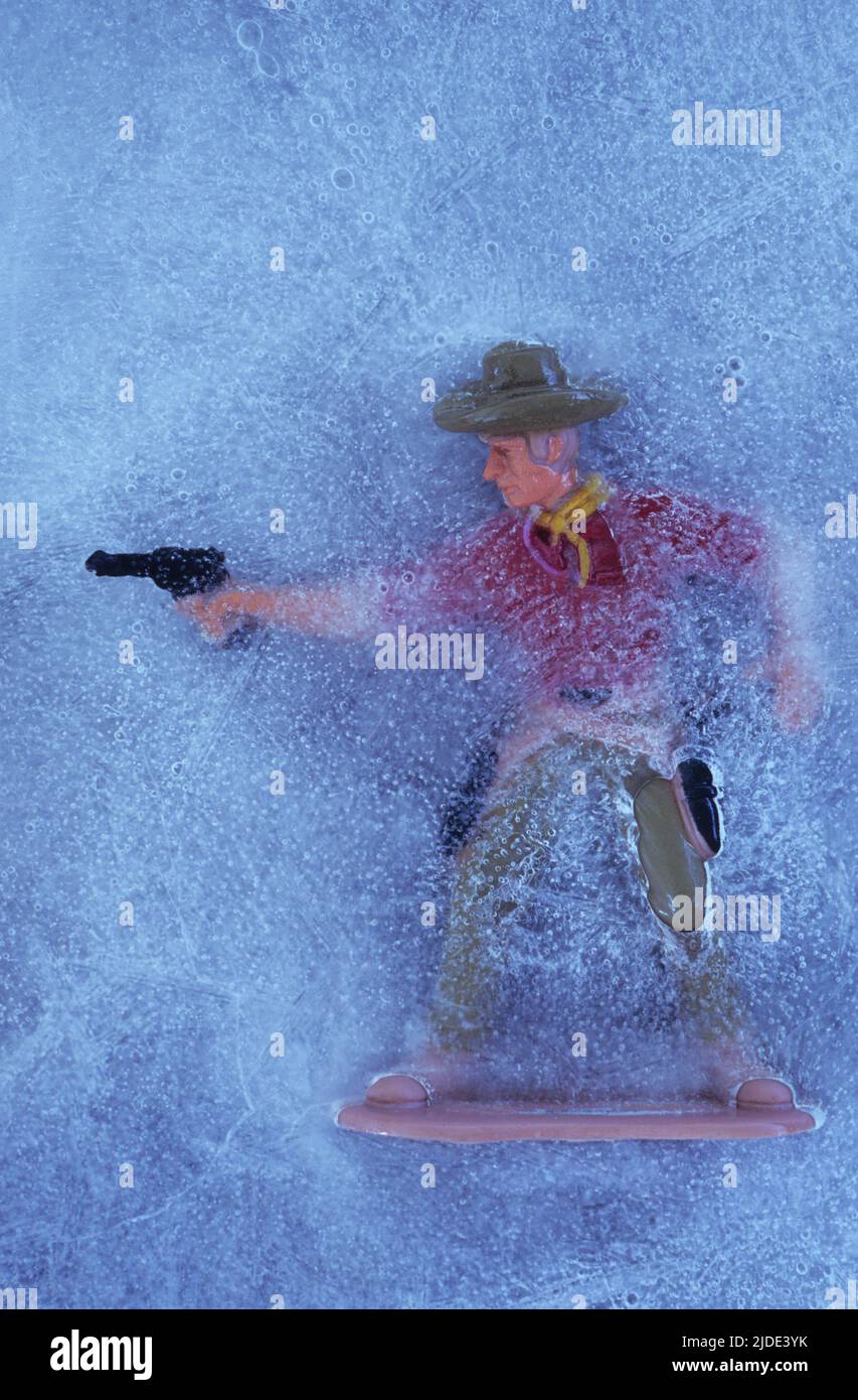 Plastic model of cowboy in ice firing his gun Stock Photo - Alamy