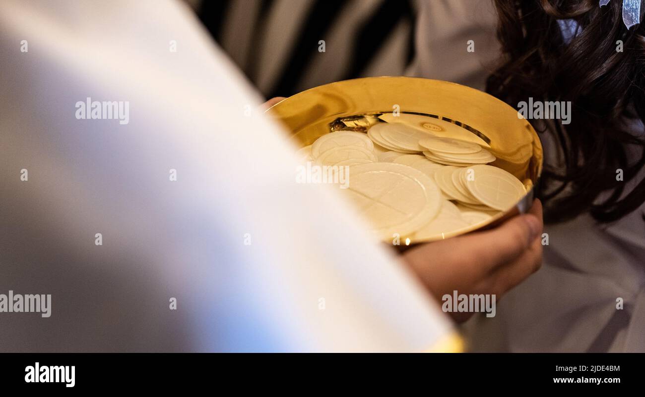 First Holy Communion, a host in a golden vessel in the boy's hands ...