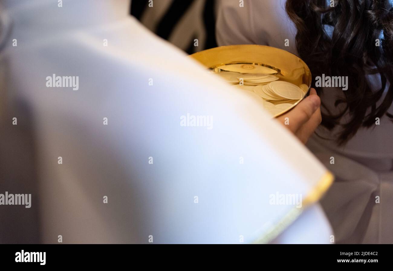 First Holy Communion, a host in a golden vessel in the boy's hands ...