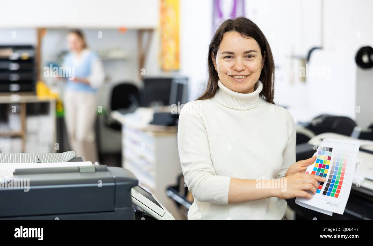 Woman employee of printing shop holds color chart in her hands Stock ...