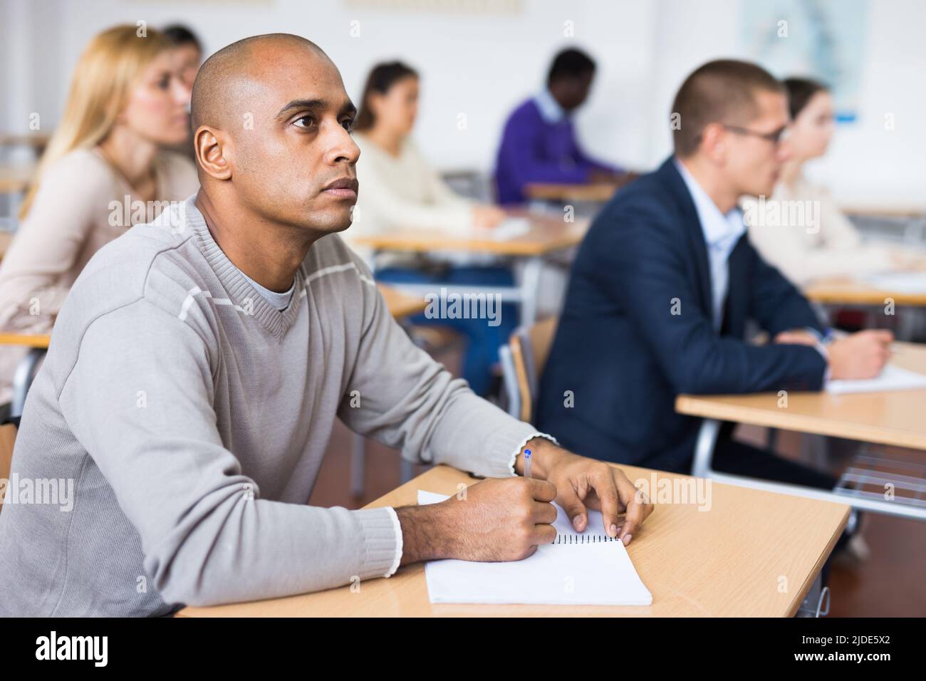 Hispanic man listening lecture during adult education class Stock Photo ...