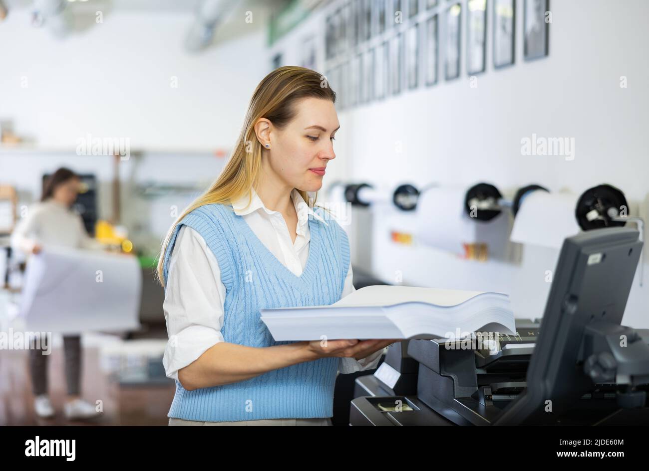 Woman loading ream of paper into printer Stock Photo - Alamy