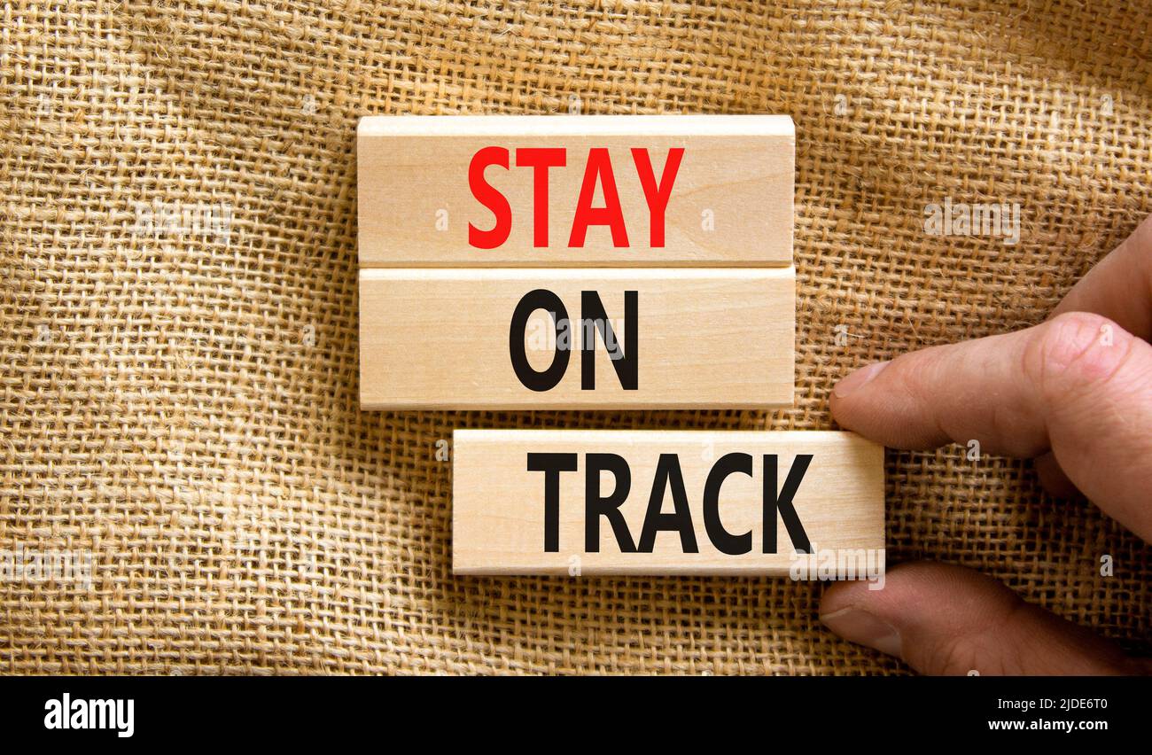 Stay on track symbol. Concept words Stay on track on wooden blocks on a ...