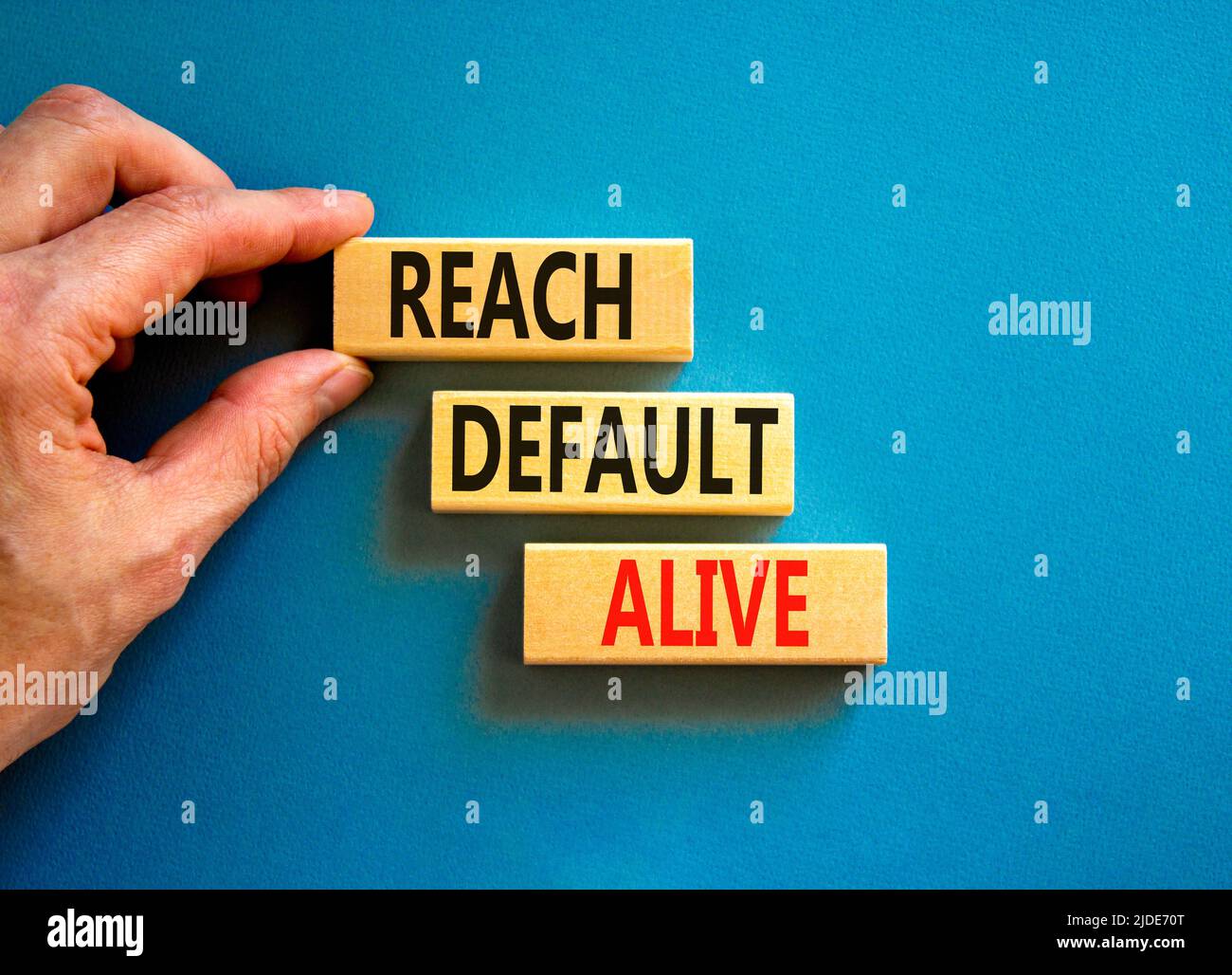 Reach default alive symbol. Concept words Reach default alive on wooden ...