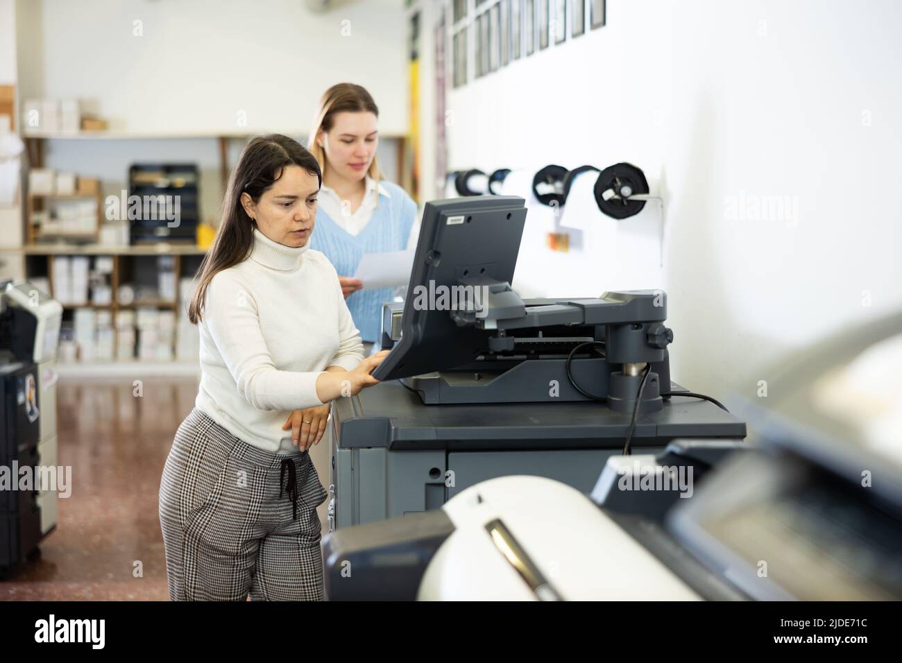 Woman working in printing office, using printer Stock Photo - Alamy