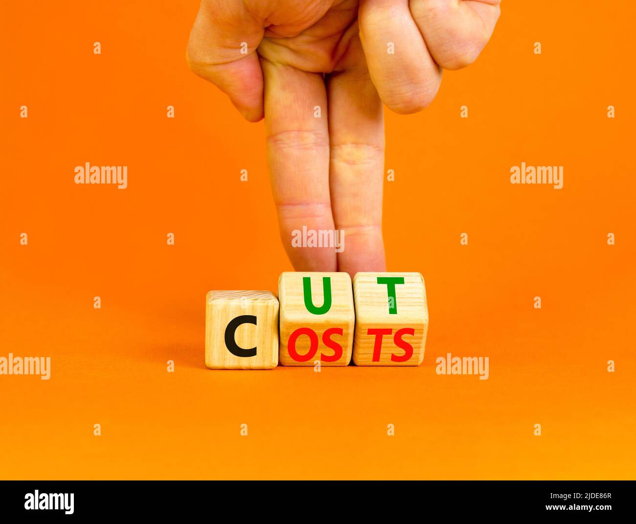 Cut costs symbol. Concept words Cut costs on wooden cubes. Businessman ...