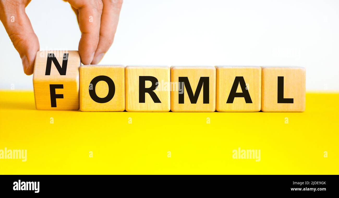 Formal or normal symbol. Businessman turns wooden cubes and changes the ...