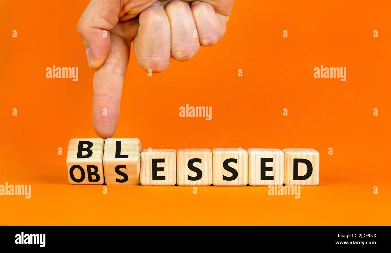 Blessed or obsessed symbol. Businessman turns wooden cubes and changes ...