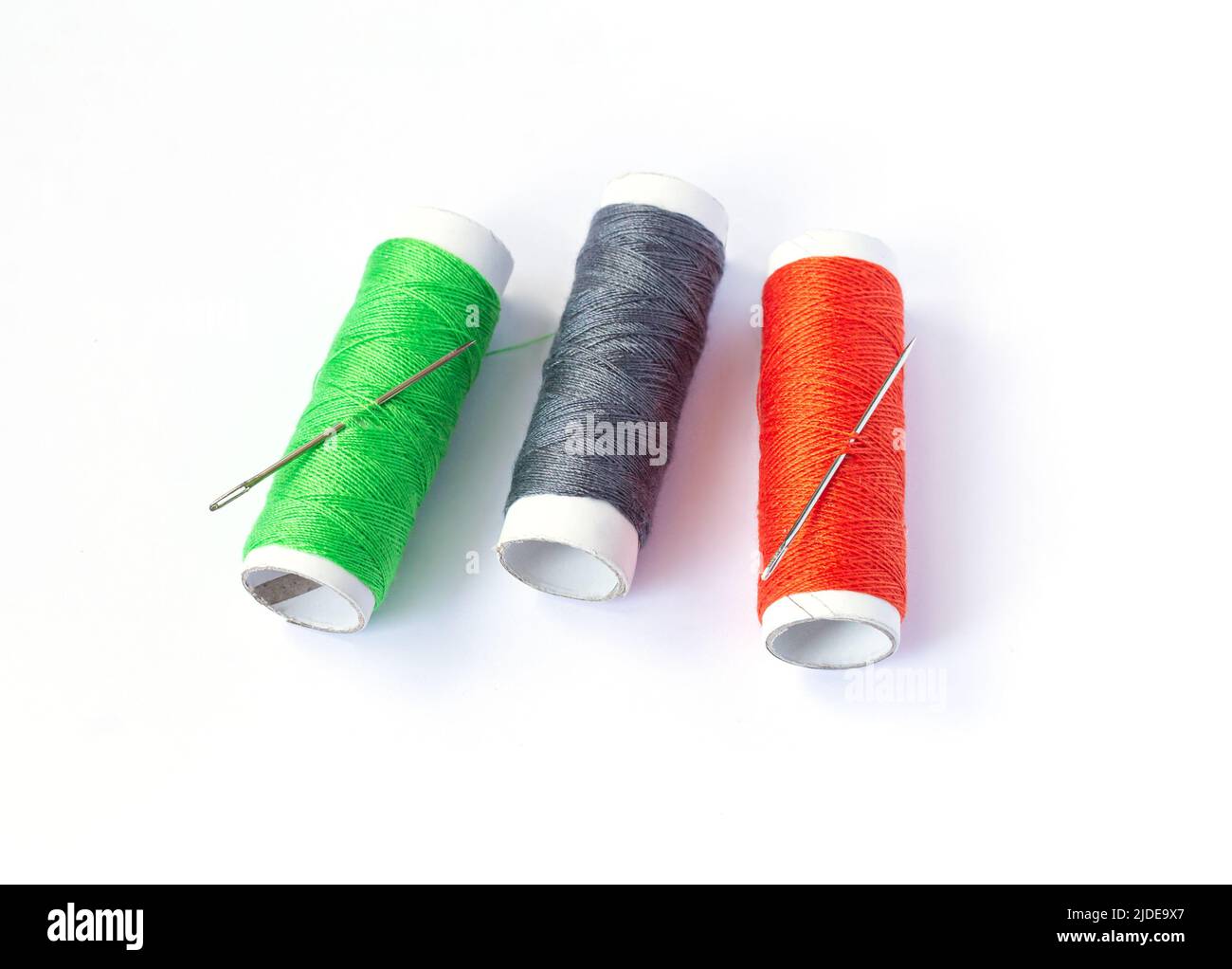 Three spools of sewing threads with needle, set of seamstress isolated ...