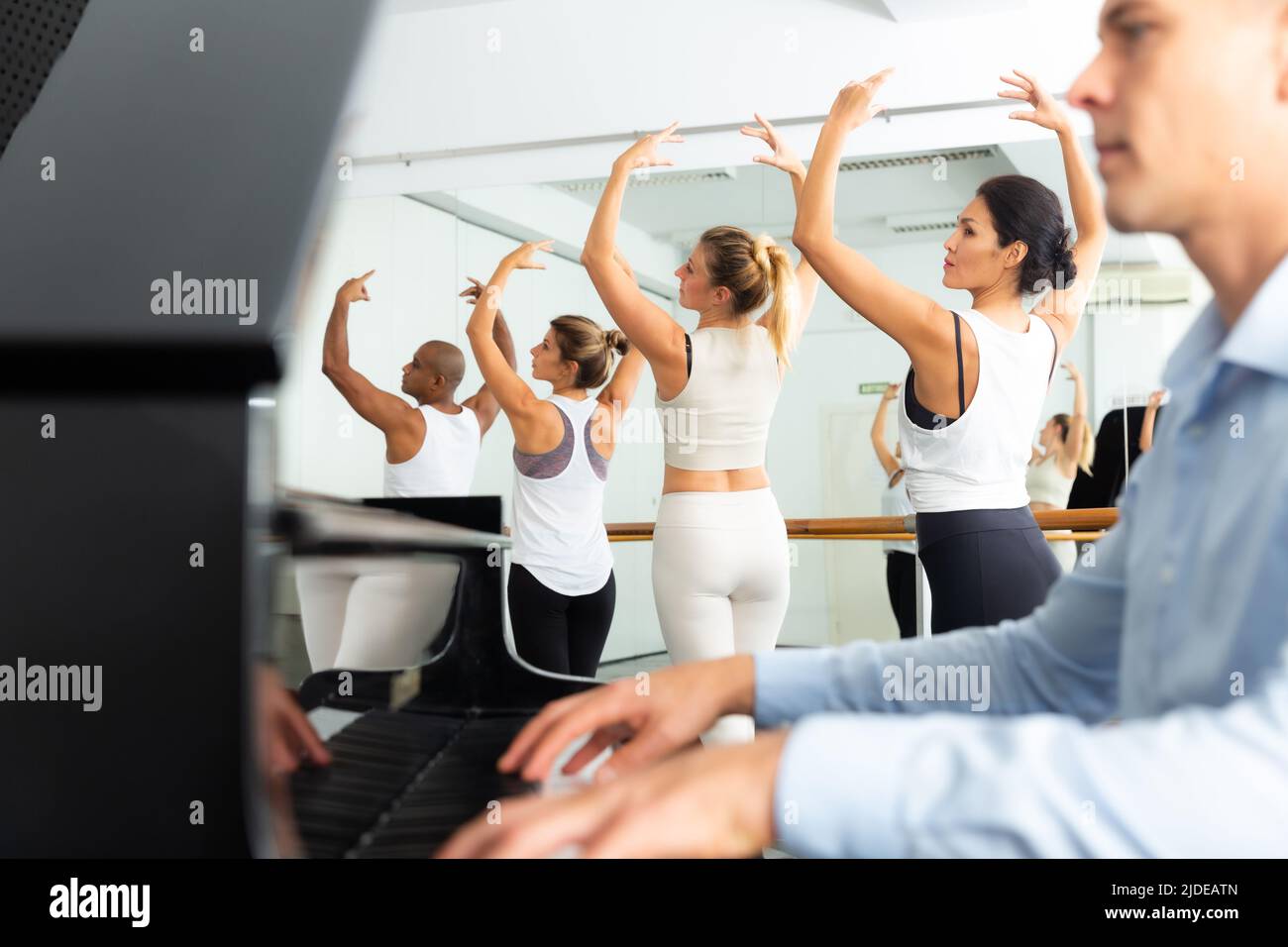 Ballet students doing exercises with musician at piano Stock Photo - Alamy