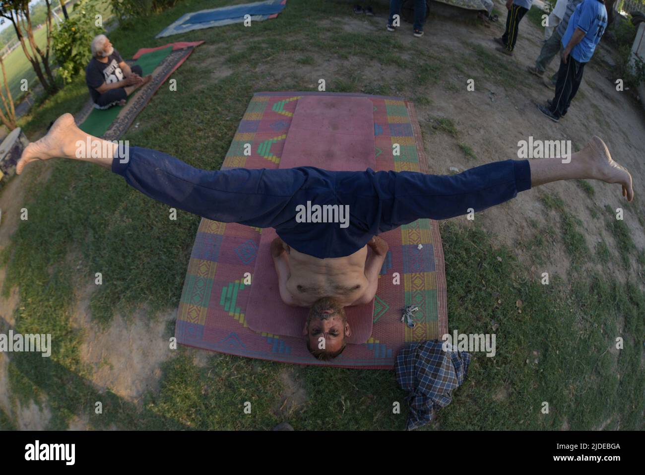 Pakistani people performing yoga session at a ground on the eve of ...